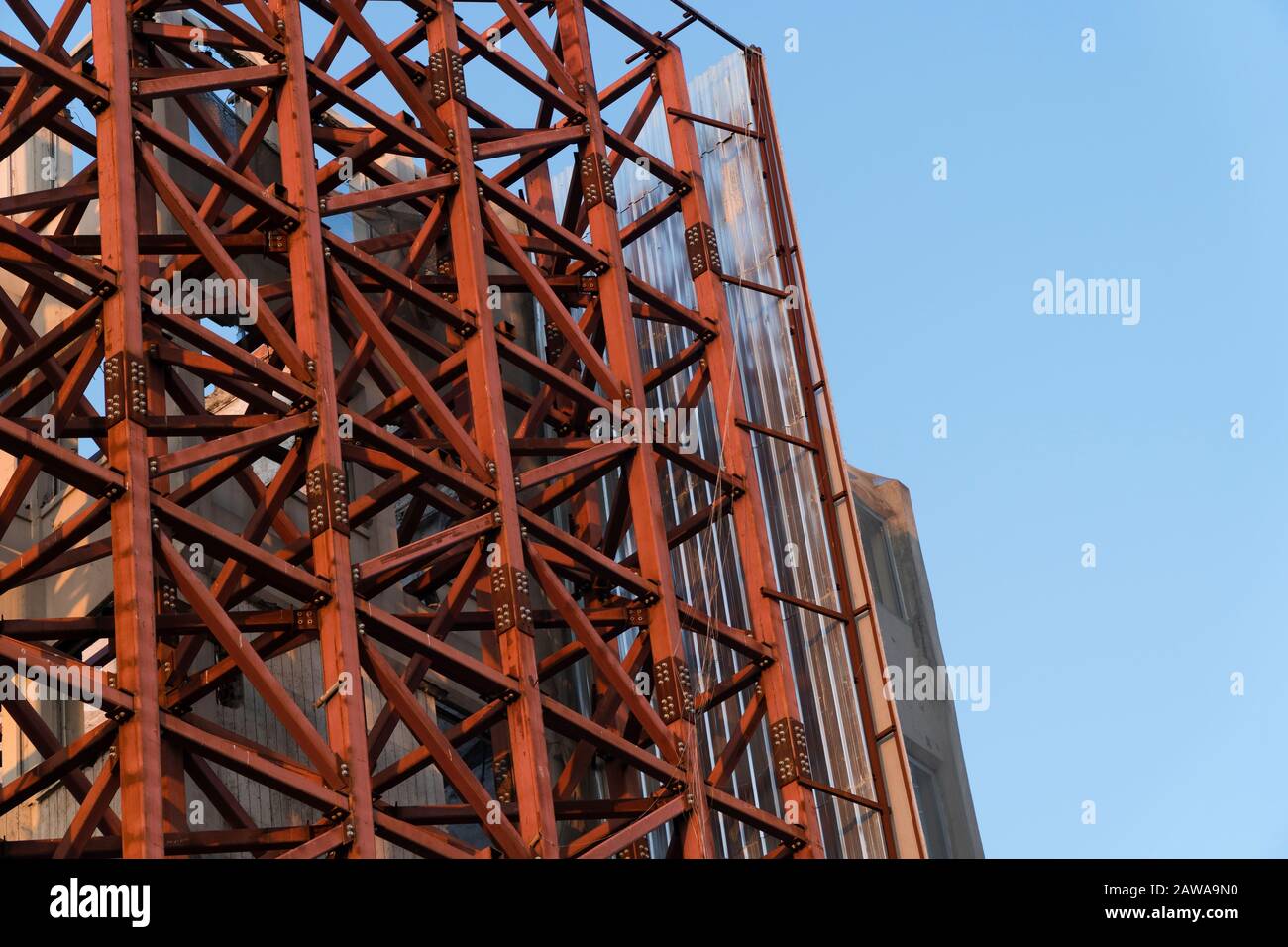 Orange colored metal scaffolding outside of a building Stock Photo - Alamy
