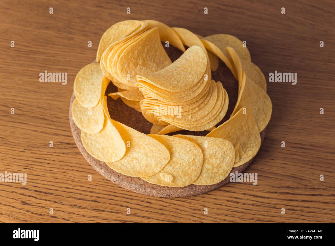Delicious potato chips, laying on wooden table background Stock Photo ...