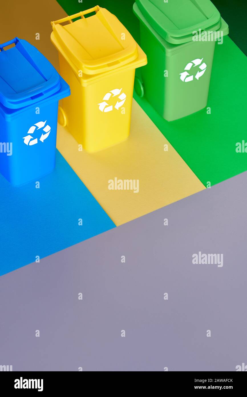 Three color coded recycle bins, isometric picture on grey paper, copy ...