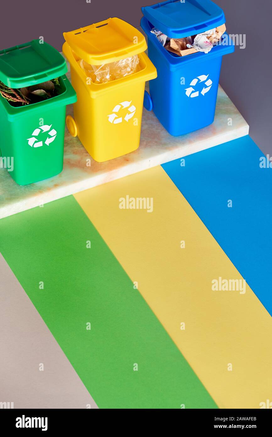 Three color coded recycle bins, isometric projection on geometric paper ...