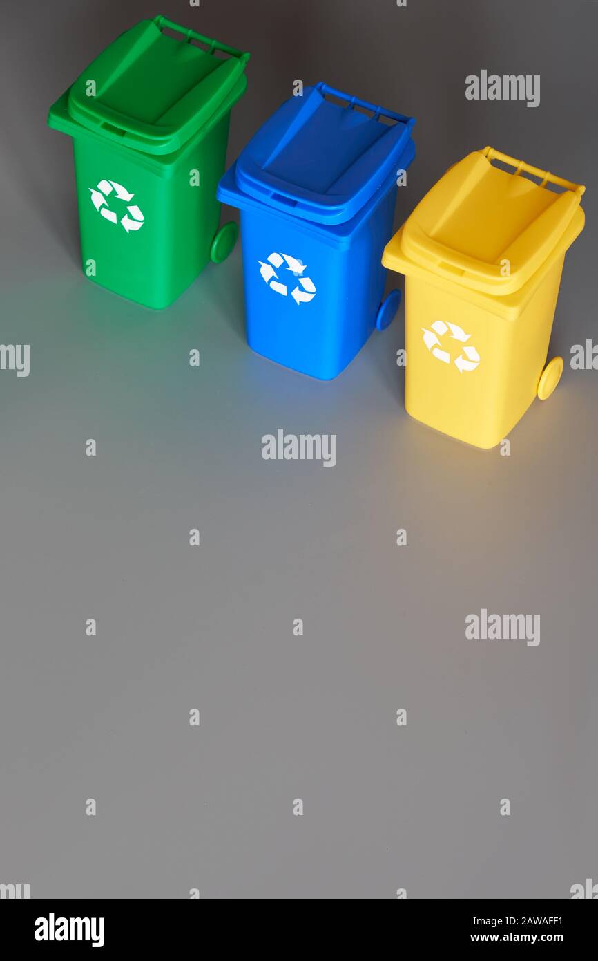 Three color coded recycle bins, isometric projection on grey background ...