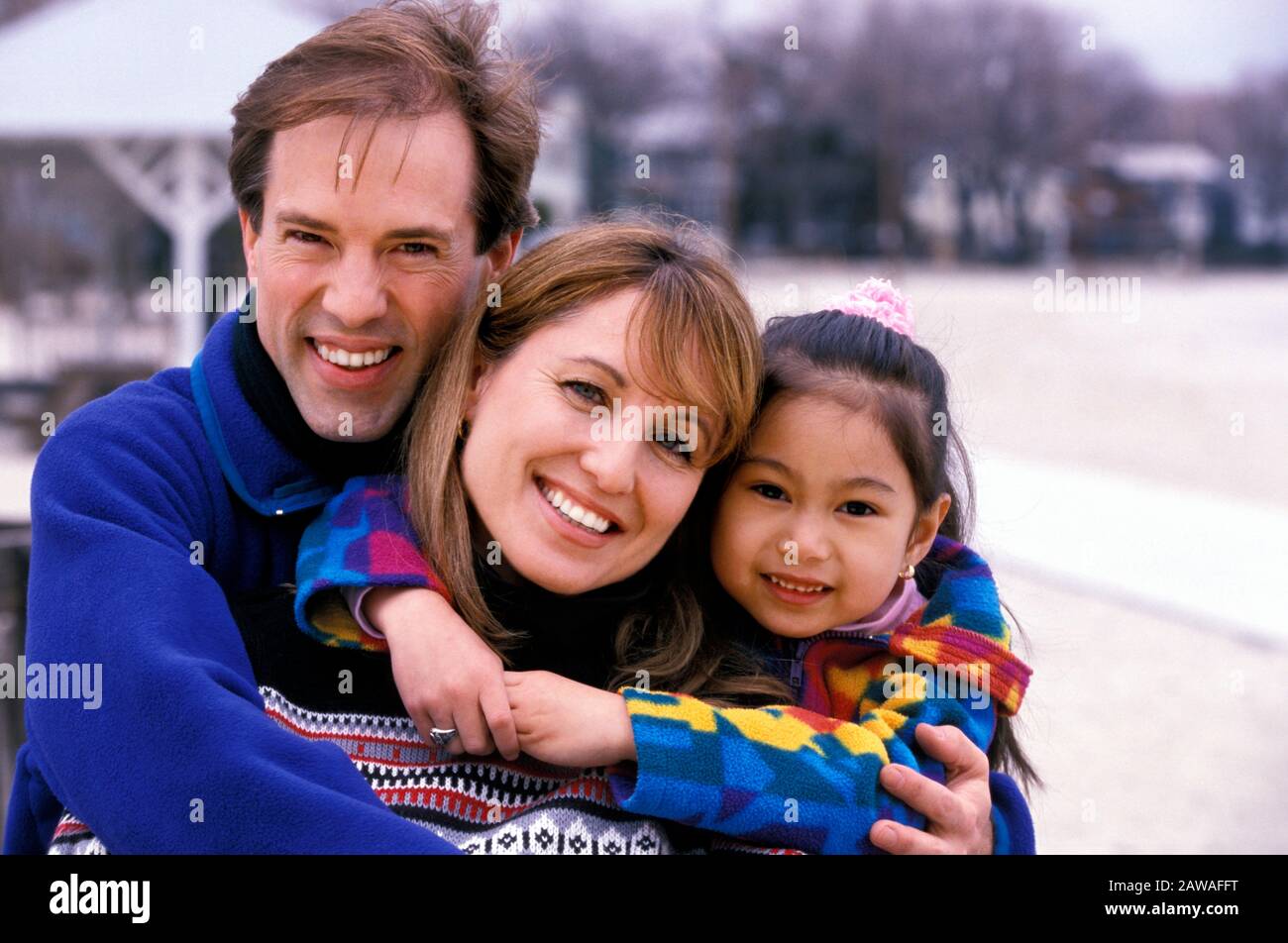 Family portrait of a white couple with Asian adopted daughter Stock ...
