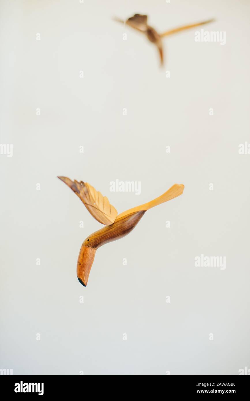 wooden birds hanging in a white room Stock Photo - Alamy
