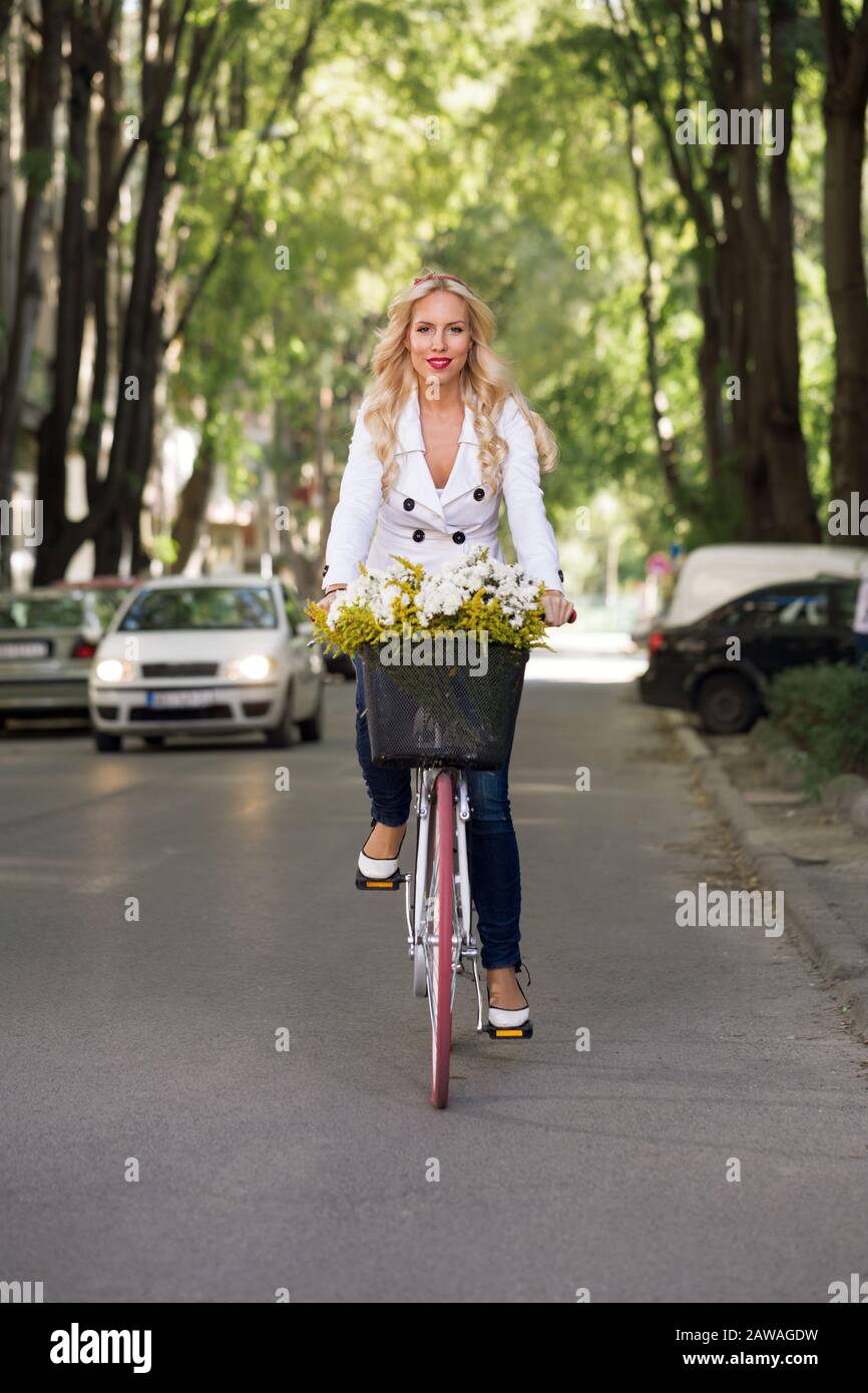 Beautiful woman riding on bike hi-res stock photography and images - Alamy