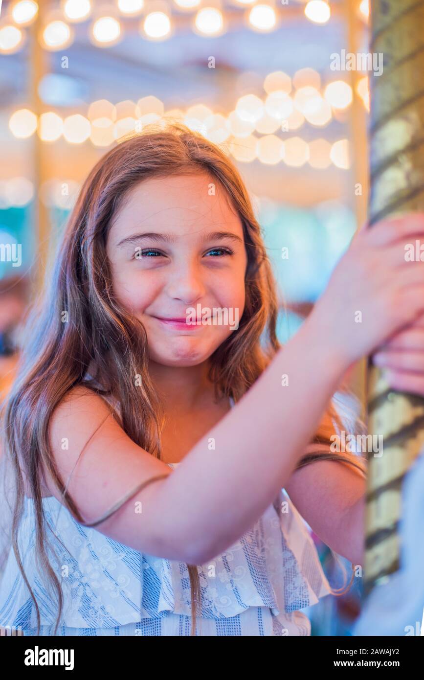 Happy Girl having fun on Carousel Stock Photo - Alamy