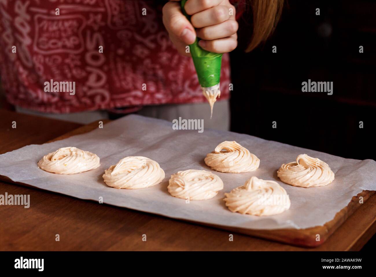 The process of cooking tasty homemade orange zefir by young lady Stock ...
