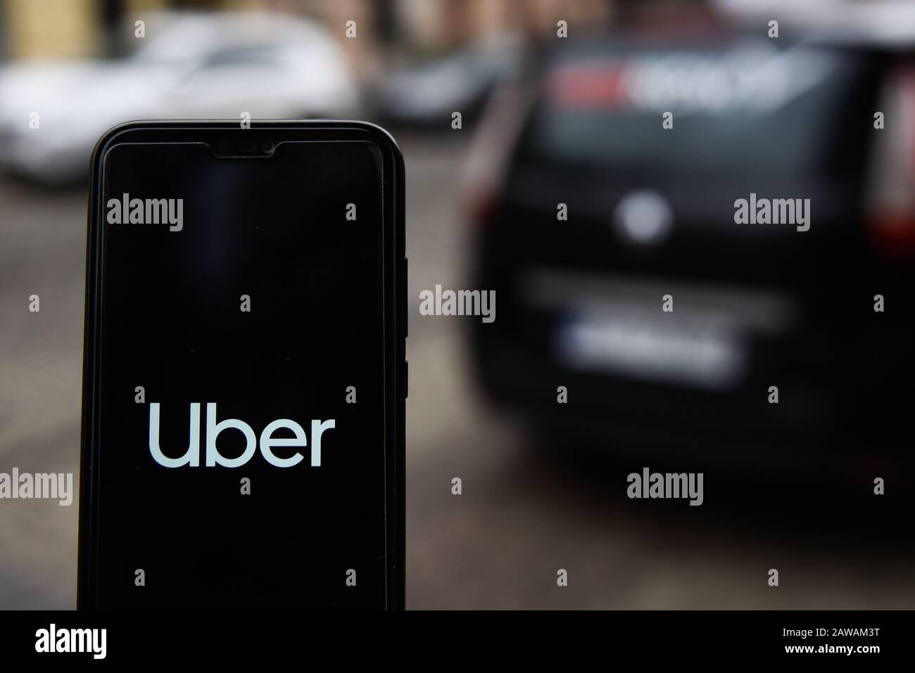In this photo illustration an Uber logo seen displayed on a smartphone ...