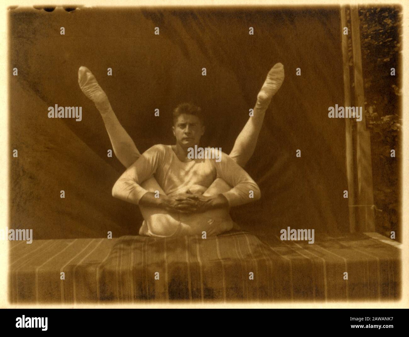 1930's , GERMANY : A young man contortionist in garden , vernacular ...