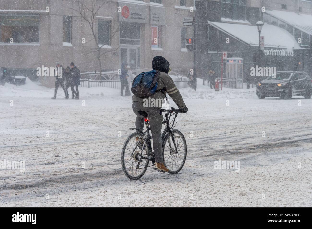 Montreal, CA, 7 February 2020: Man riding bike in Downtown Montreal ...