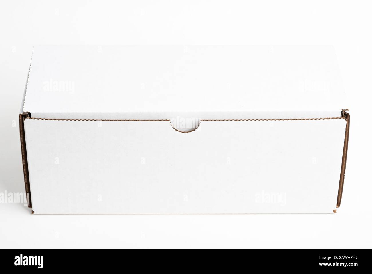 A close-up studio shot of a generic closed white packaging box set on a ...
