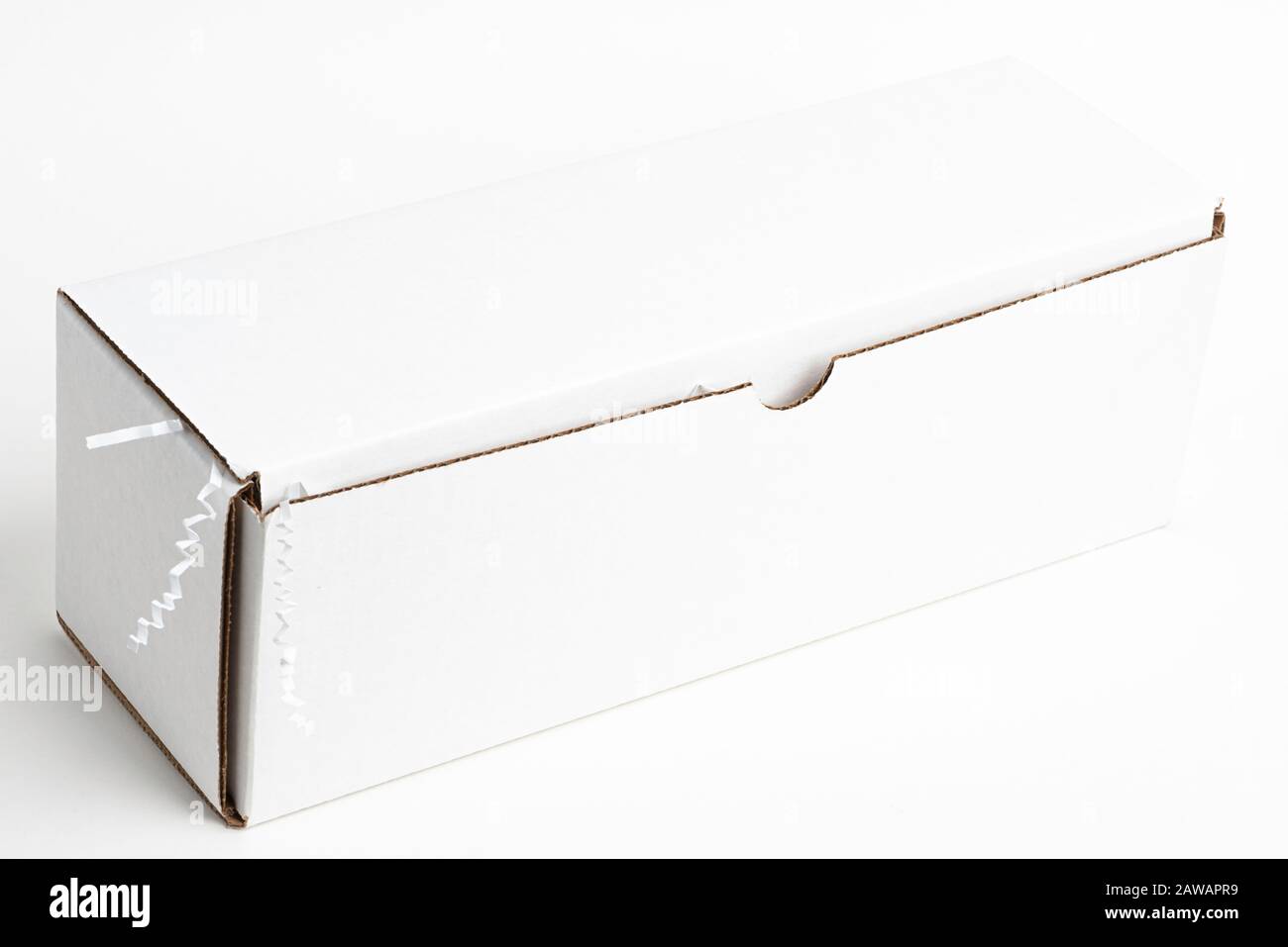 A close-up studio shot of a generic closed white packaging box set on a ...