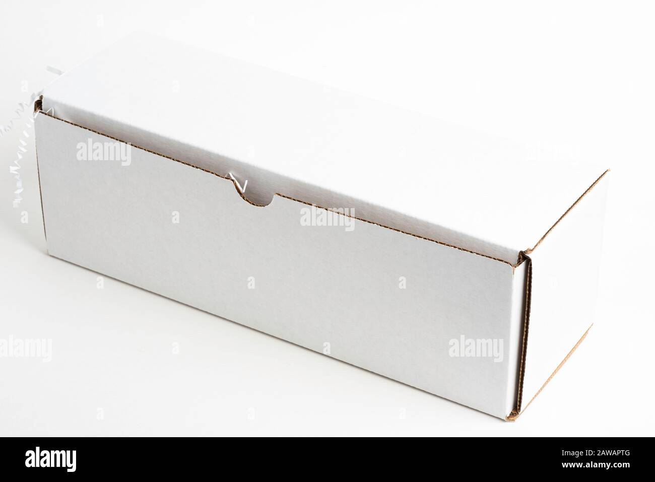 A close-up studio shot of a generic closed white packaging box set on a ...