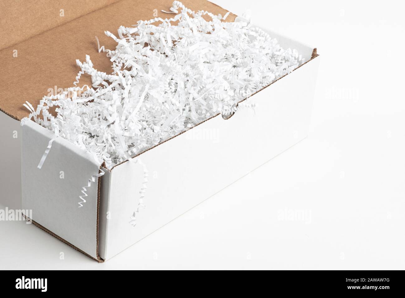 A close-up studio shot of a generic open white packaging box set on a ...