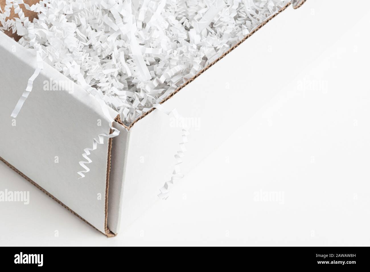 A close-up studio shot of a generic open white packaging box set on a ...