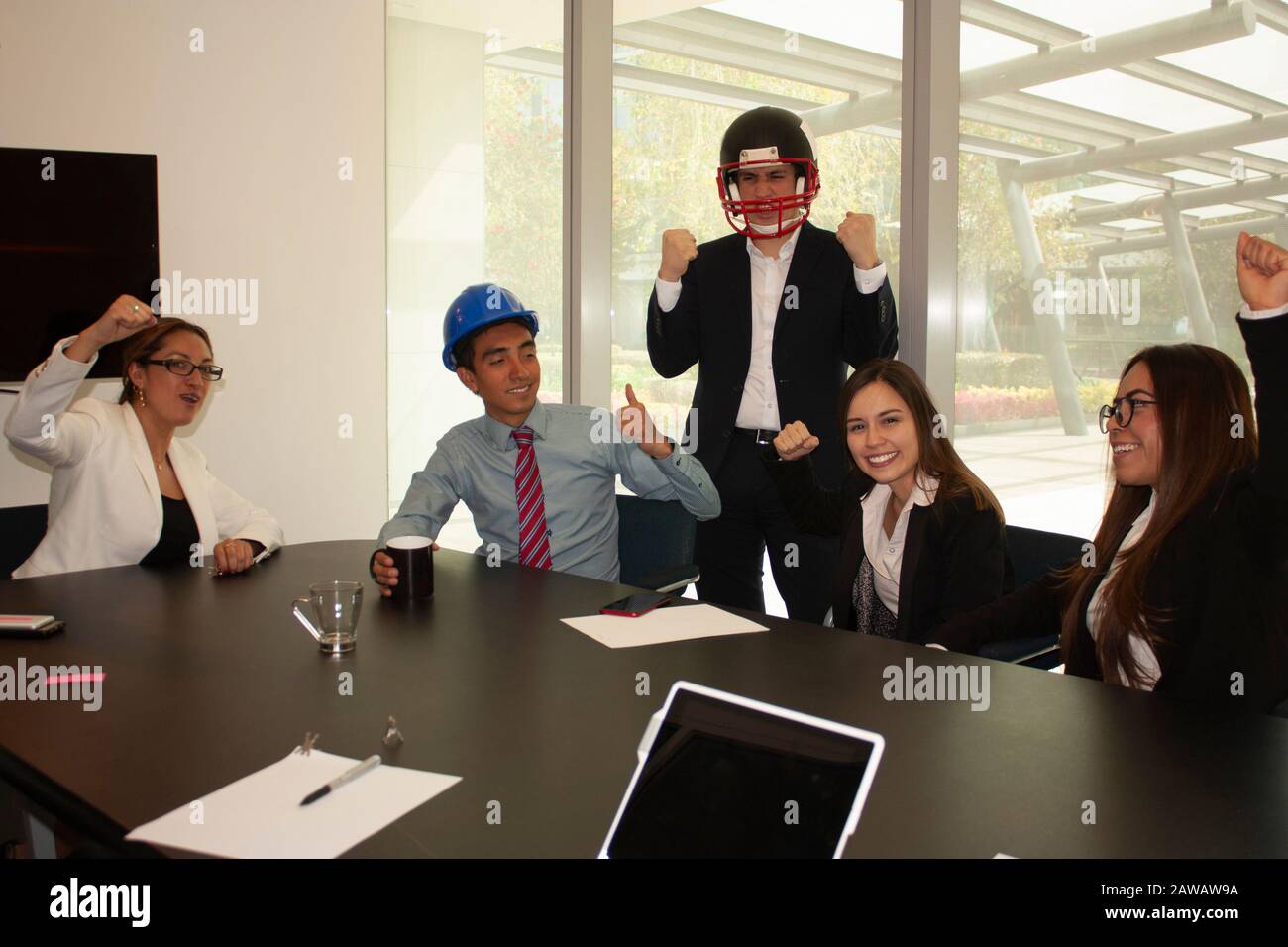 Work team excited about the attitude of its leader who wears an ...