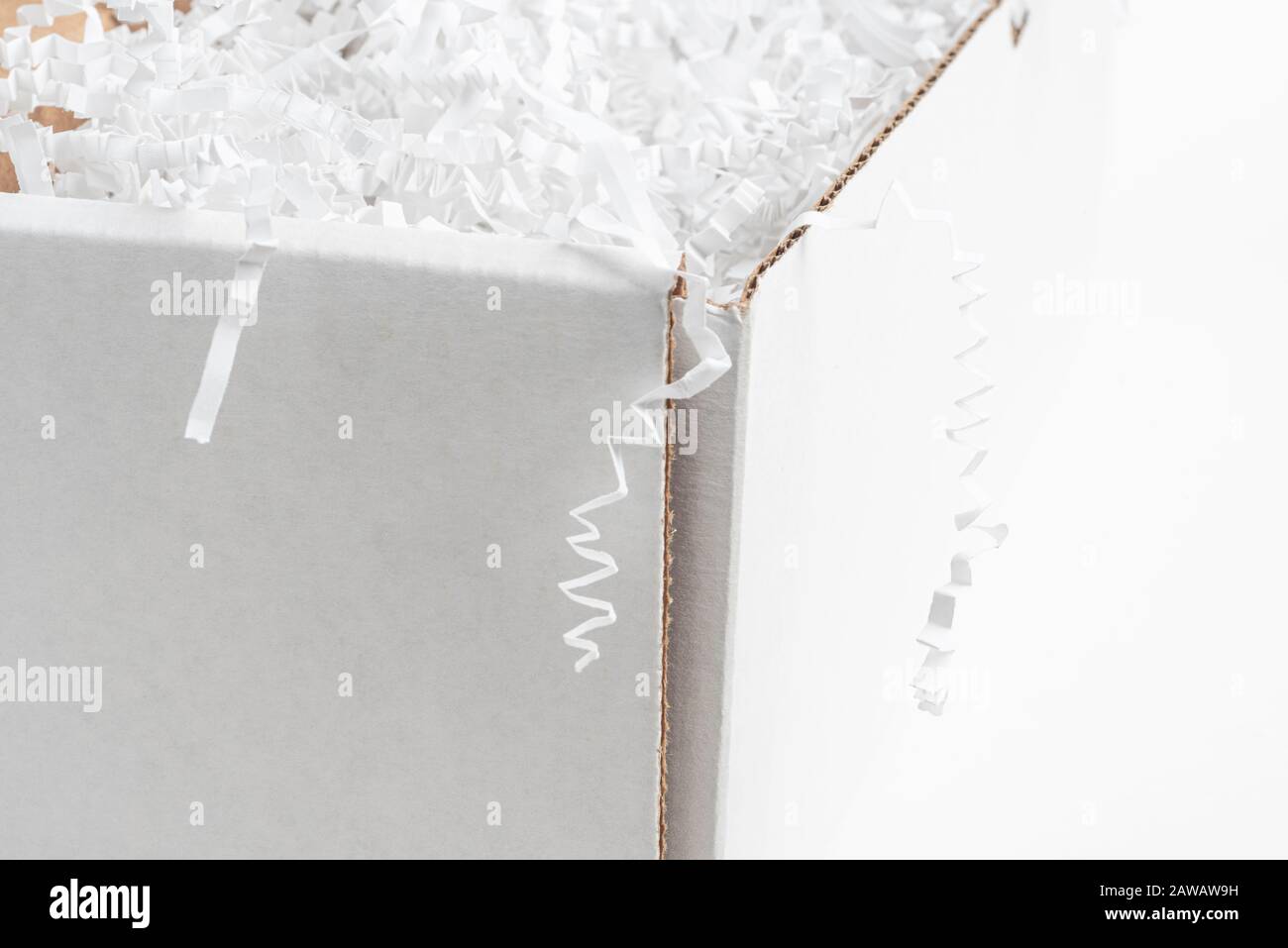 A close-up studio shot of a generic open white packaging box set on a ...