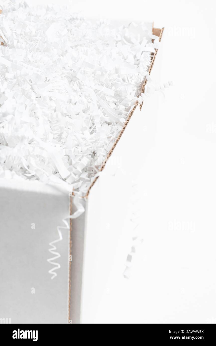 A close-up studio shot of a generic open white packaging box set on a ...