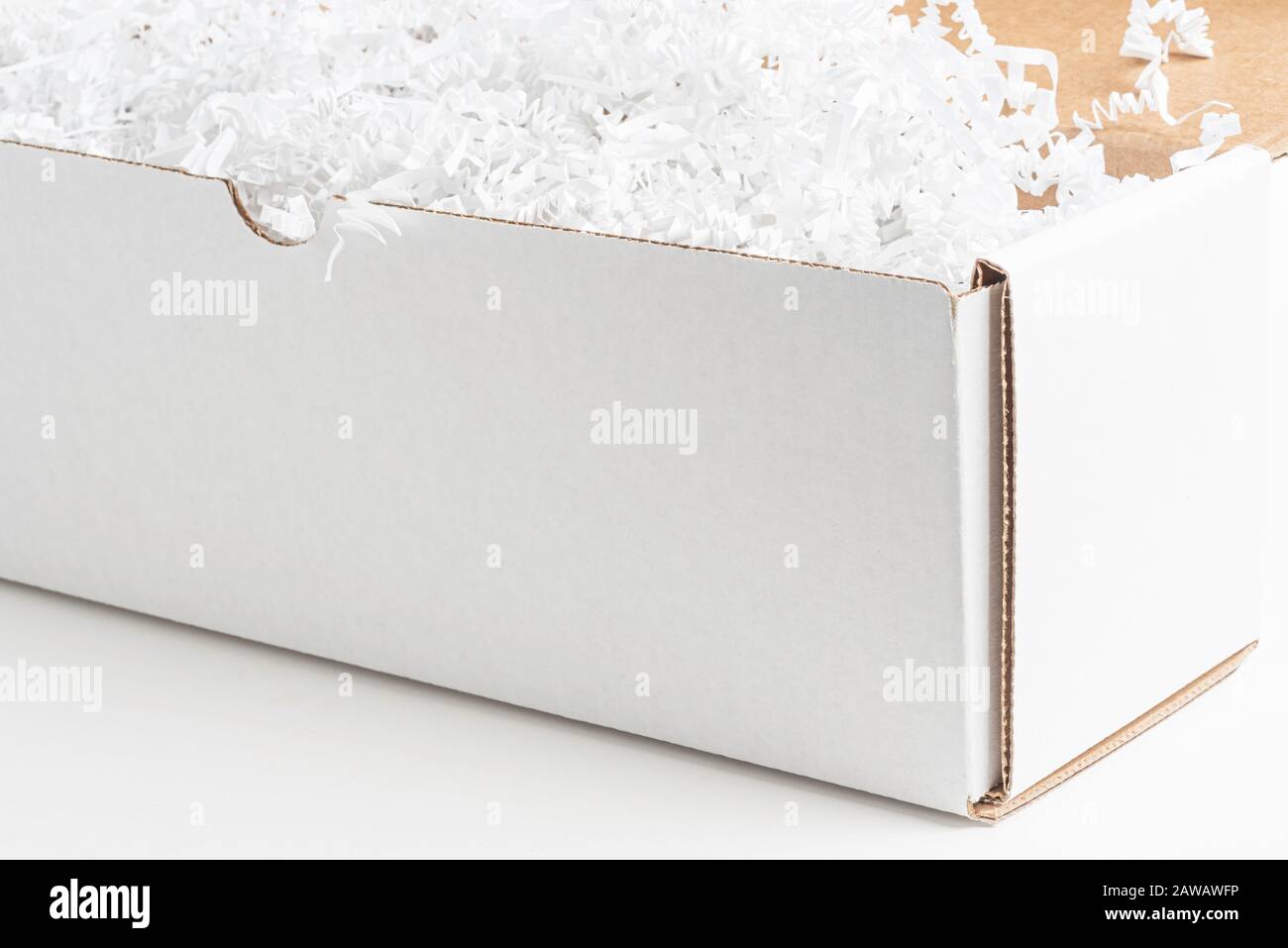 A close-up studio shot of a generic open white packaging box set on a ...