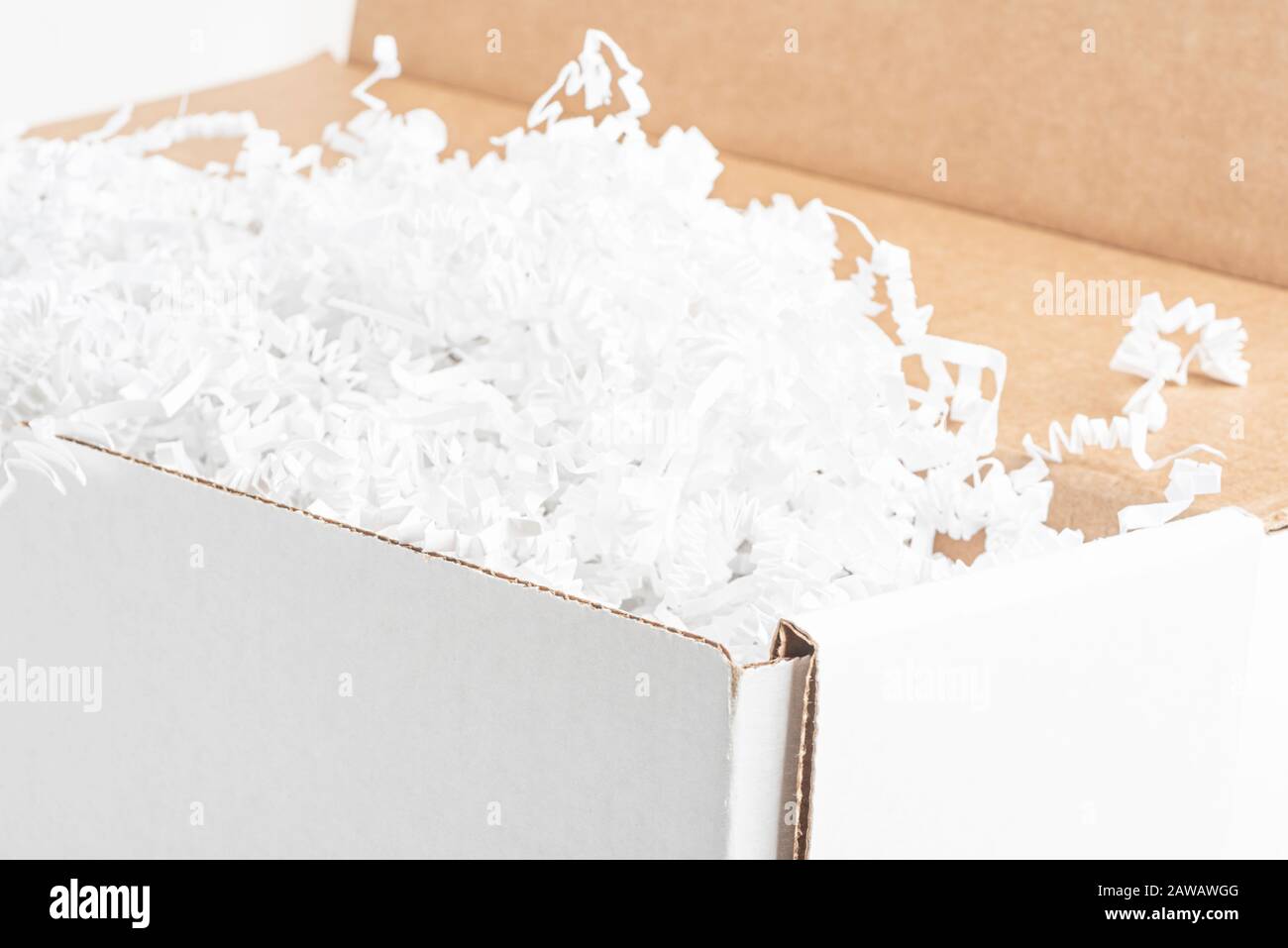 A close-up studio shot of a generic open white packaging box set on a ...