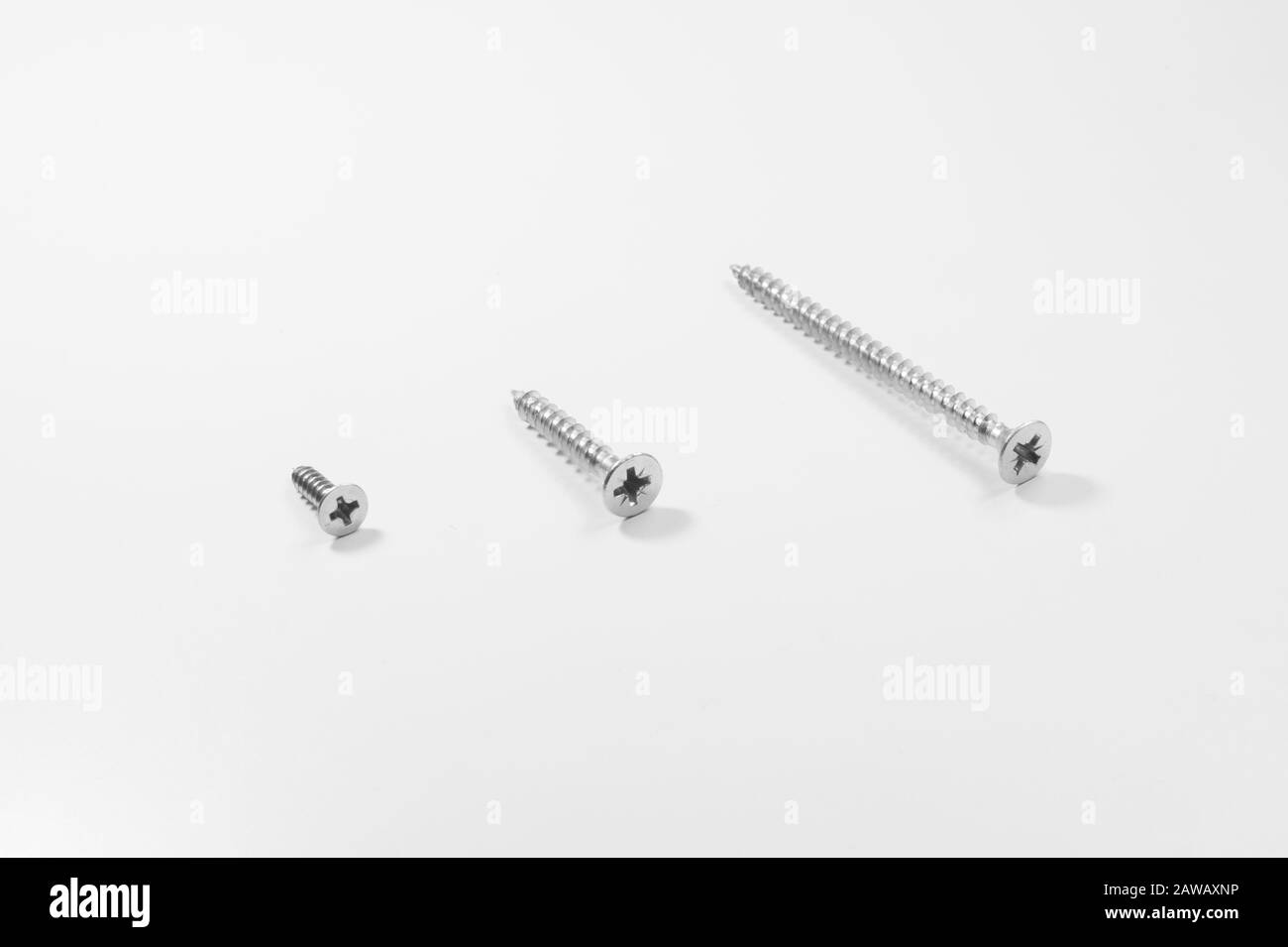 Steel screw on a white background. working tools Stock Photo - Alamy