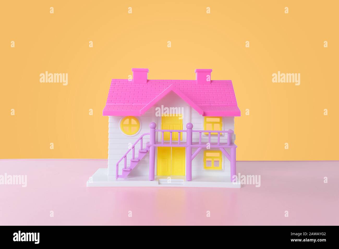 Colorful toy house on yellow background. Conceptual real estate ...