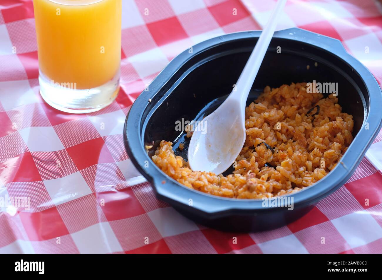 Cooked spicy rice in a packet with orange juice on table Stock Photo ...