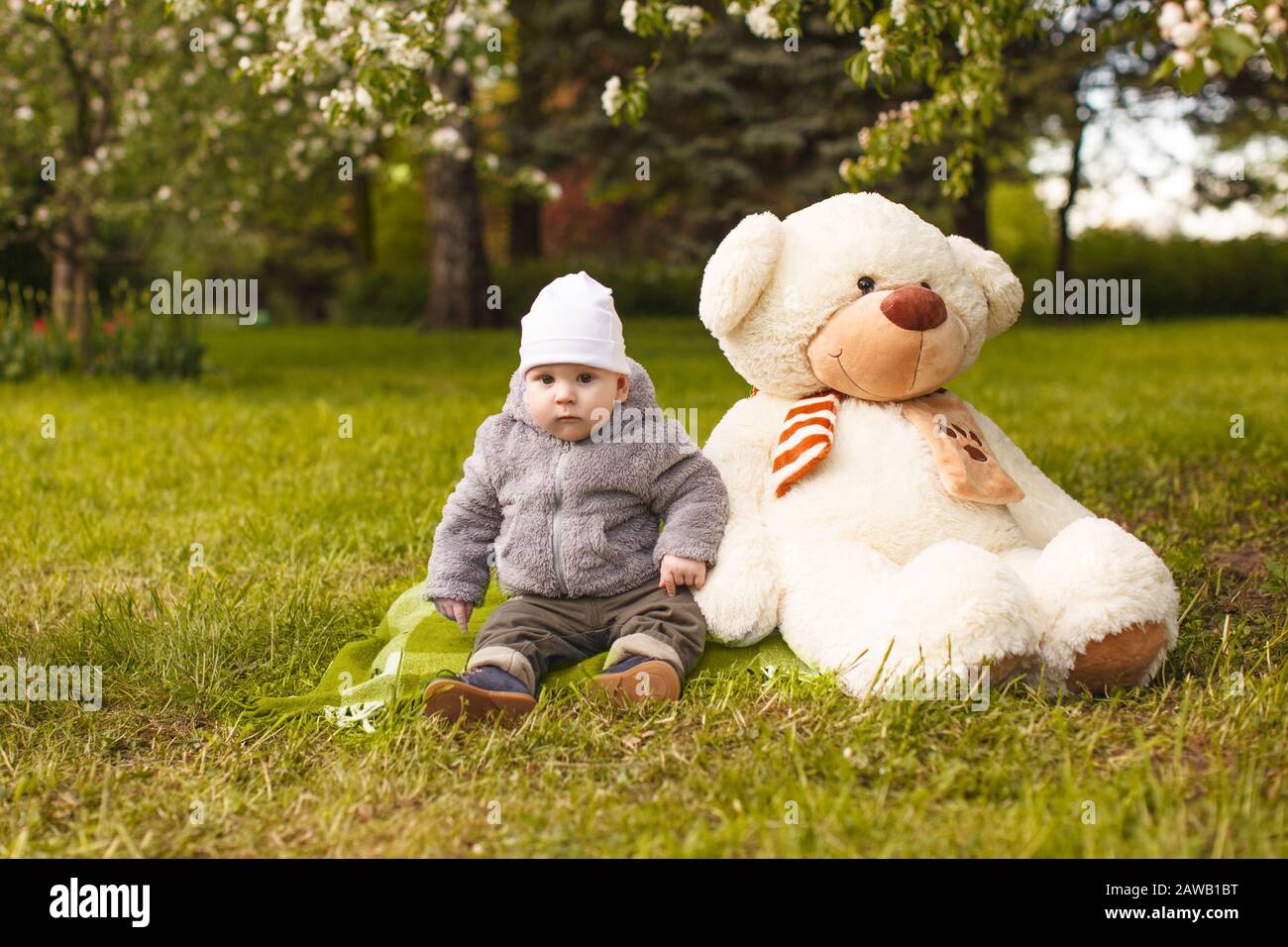 Baby in the park in the rays of sunset. Toddler on the nature outdoors ...