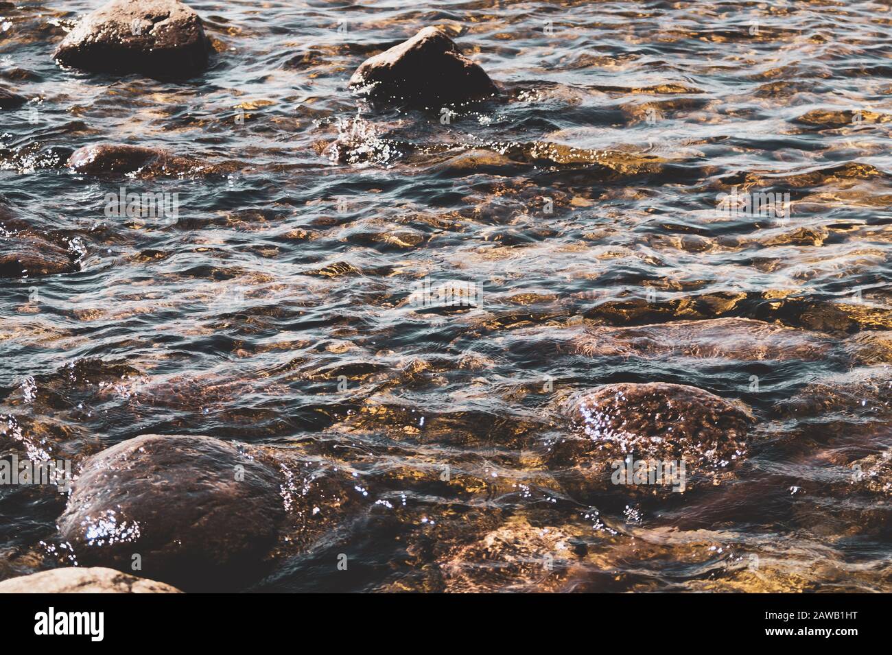 Shiny transparent water. clear water with pebbles and stone on the ...