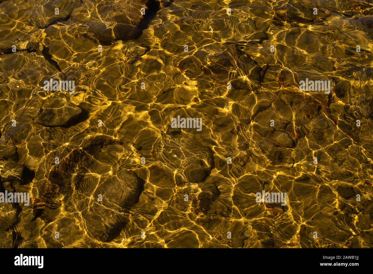 Shiny transparent water. clear water with pebbles and stone on the ...