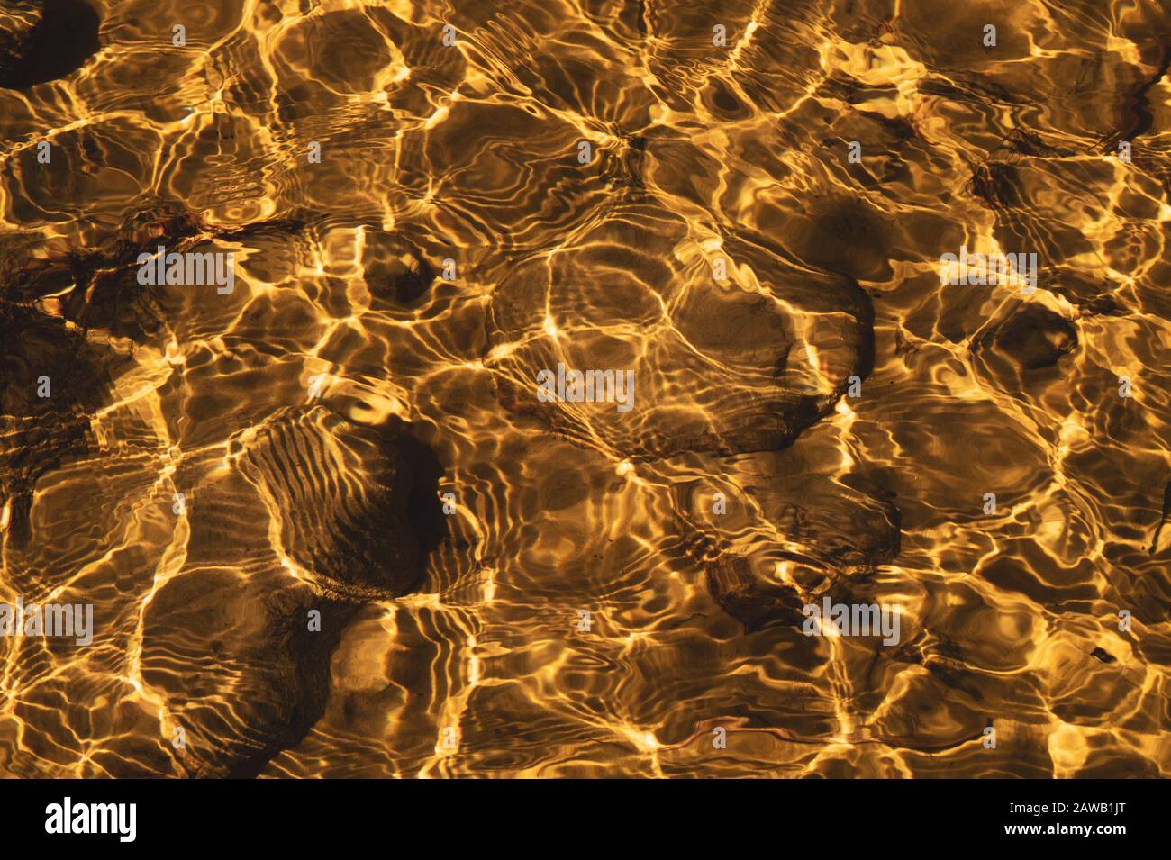 Shiny transparent water. clear water with pebbles and stone on the ...
