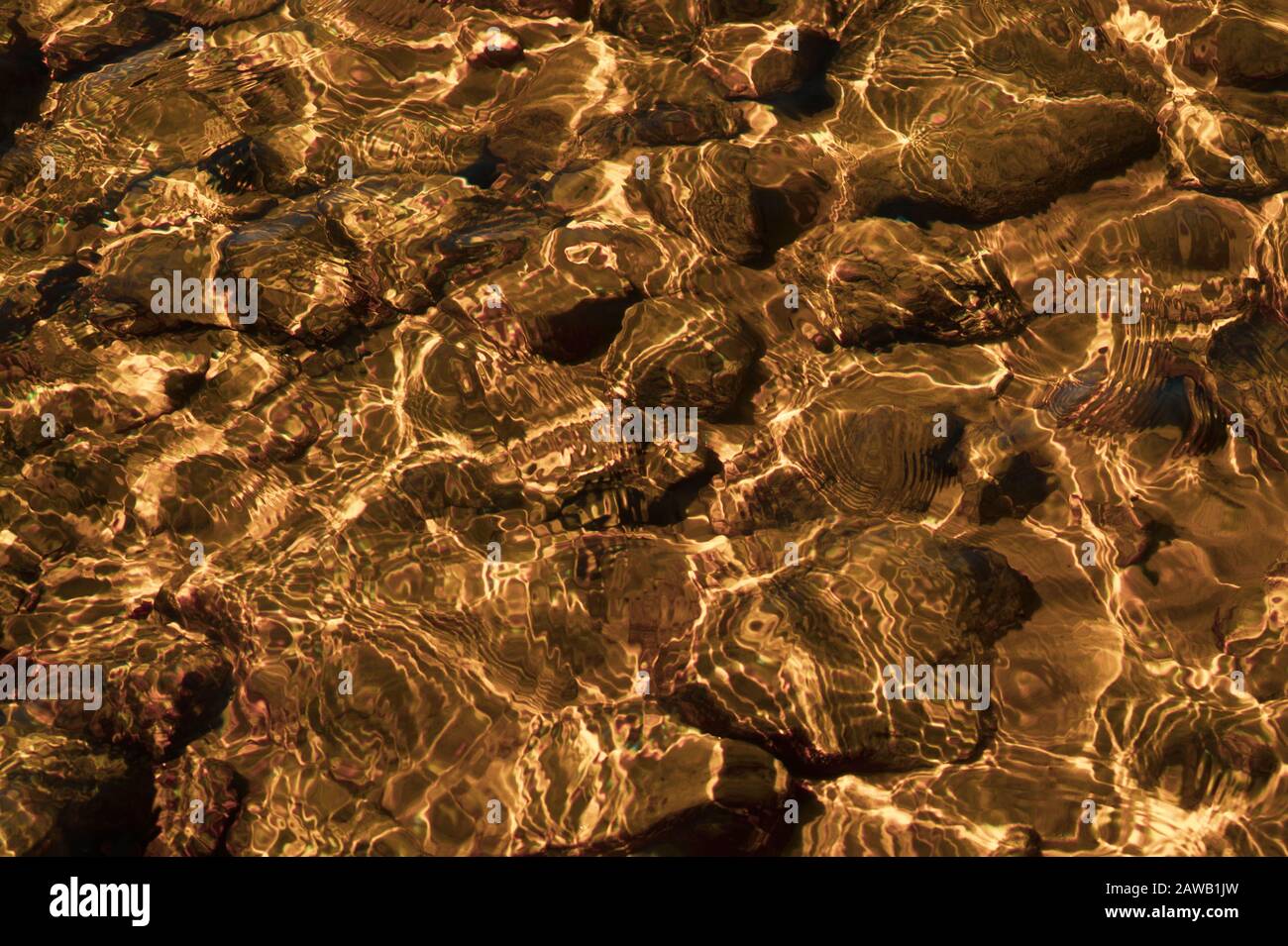 Shiny transparent water. clear water with pebbles and stone on the ...