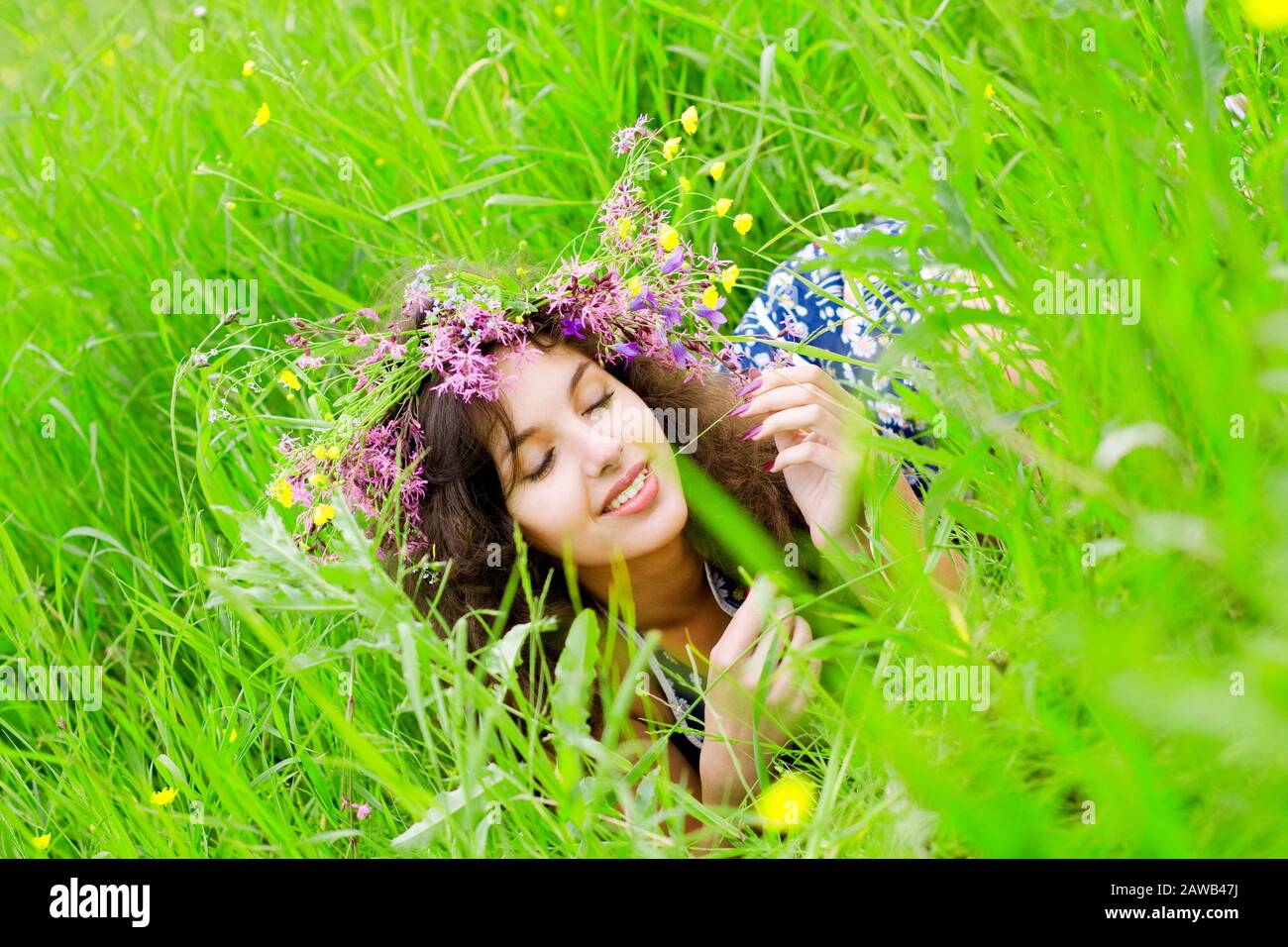 The image of a beautiful girl, lying on the grass field Stock Photo - Alamy
