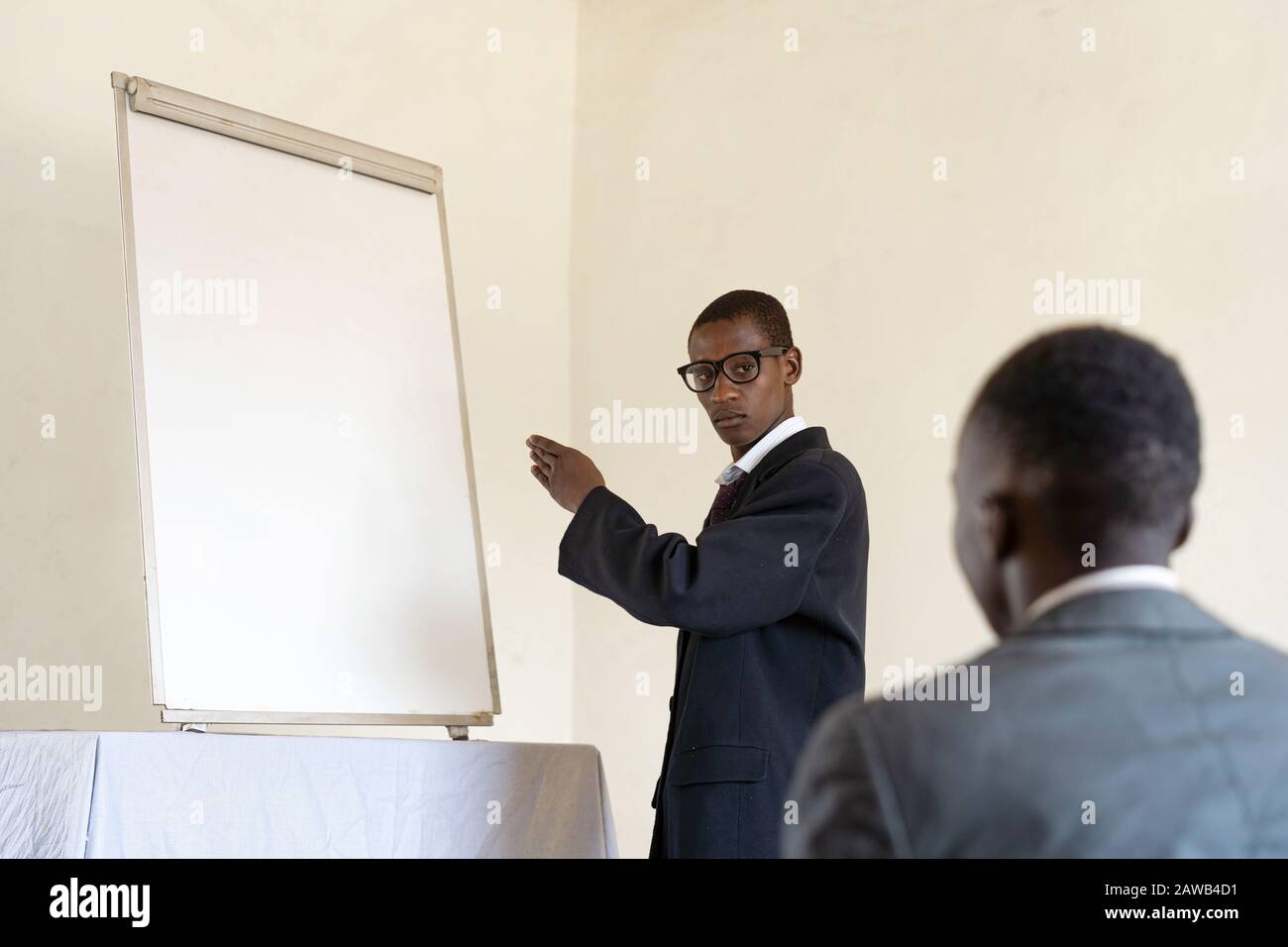 African Black Ethnicity Working Man presenting a project and looking ...
