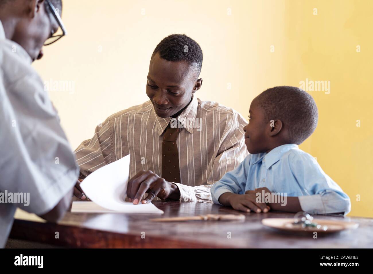 Black African dad and son father and child working together and signing ...