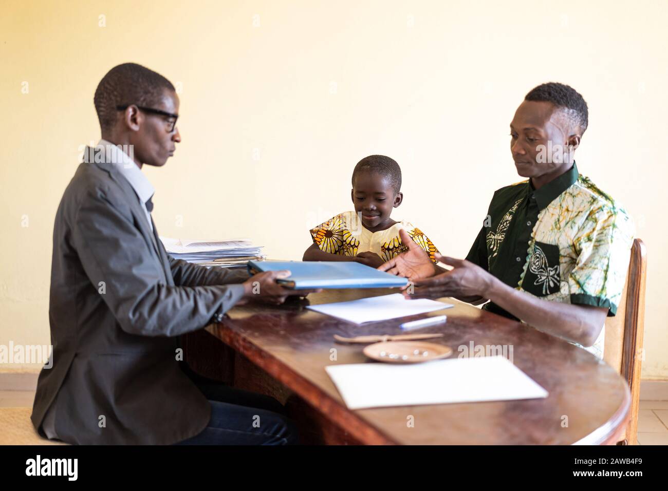 Authentic African black dad and boy kid getting documents from adoption ...