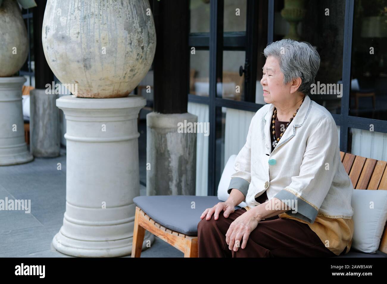 old elderly senior elder woman resting relaxing resting on terrace ...