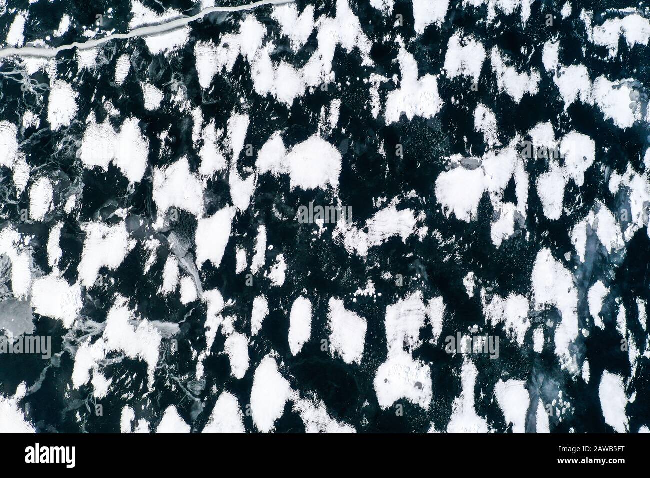 Aerial view of a frozen lake surface. Aerial Snow pattern on the frozen ...