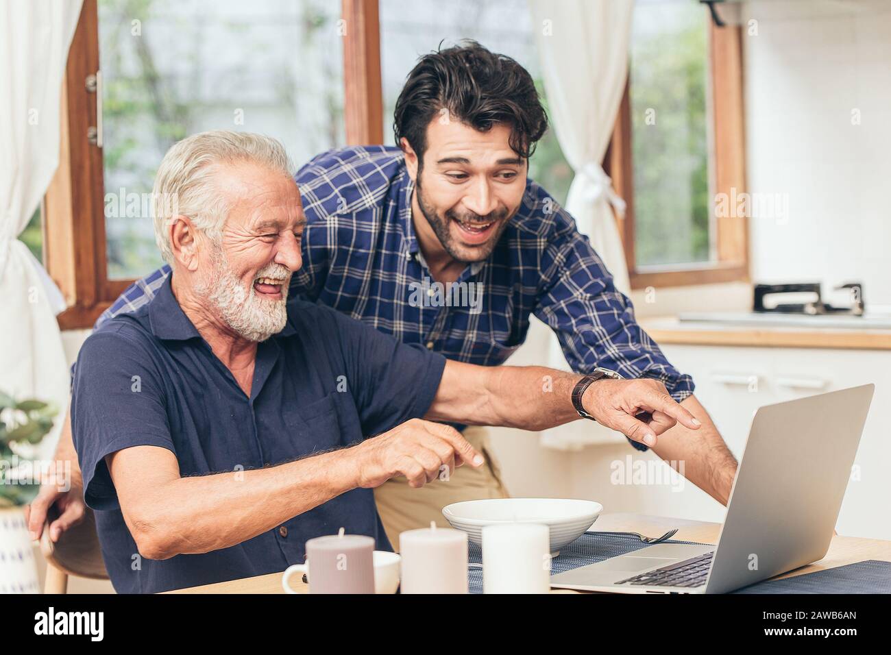 old man fun smile happy to looking at laptop with son. using ...