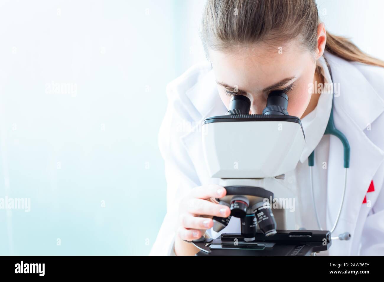 medical doctor scientist working women looking at microscope in science ...