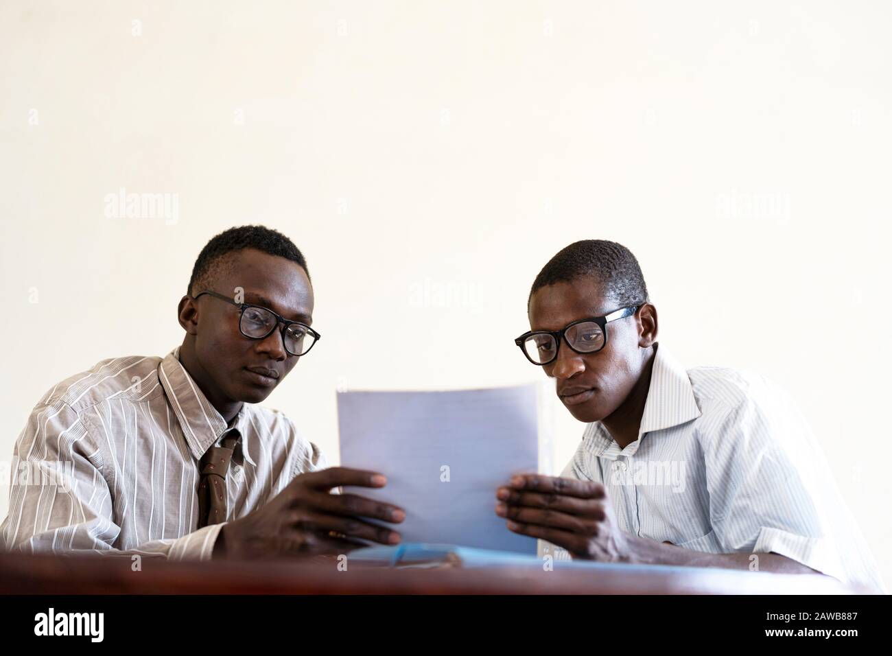 Two working African Business People with Glasses, Documents and ...