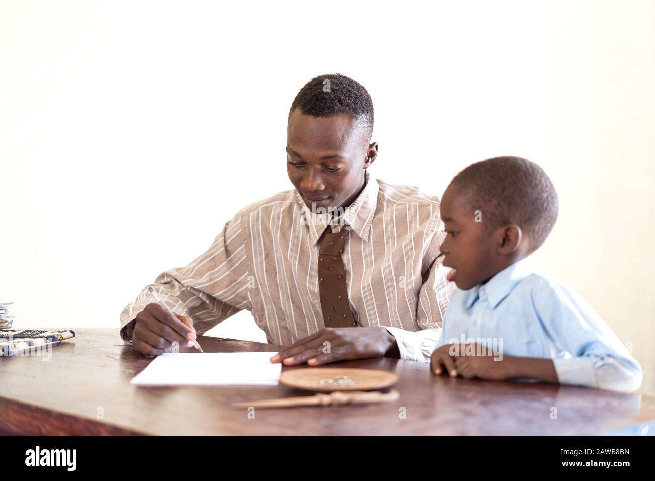 African dad and son, happy father and son go together to elementary ...