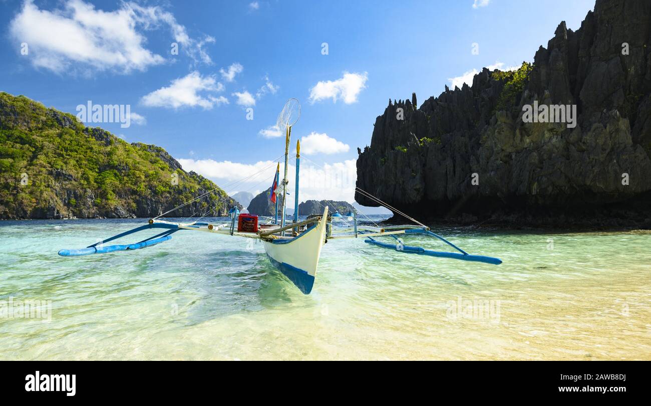 Stunning view of a Bangka floating on a turquoise, crystal clear sea. A ...
