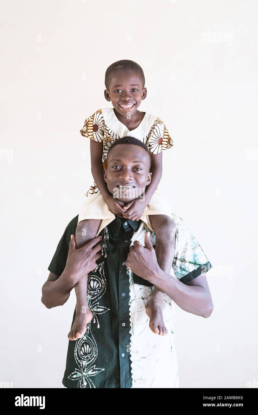 African boy and father posing in front of camera having fun smiling and ...