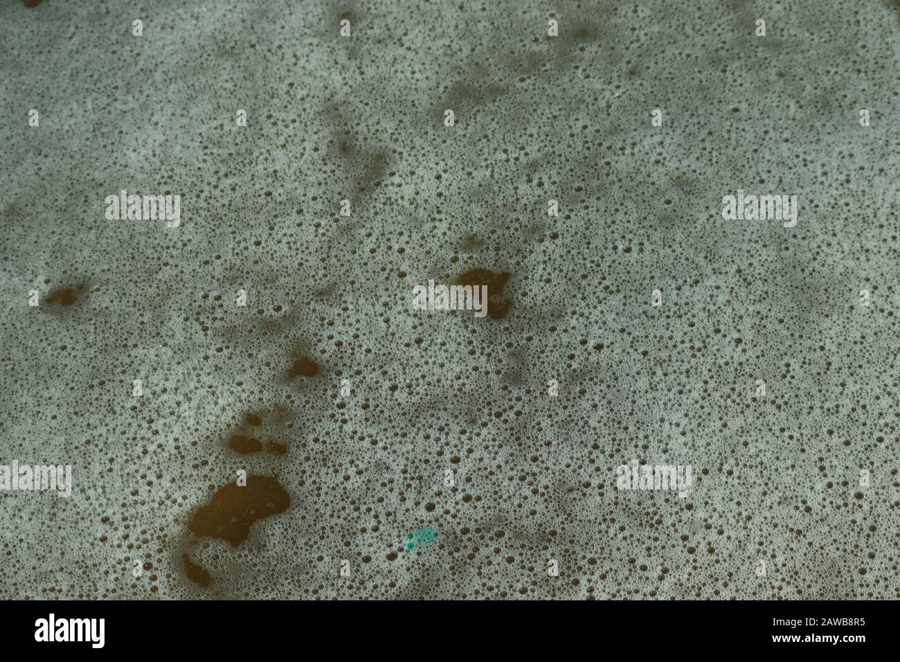 close-up of white bubble from water wave on beach, water background ...