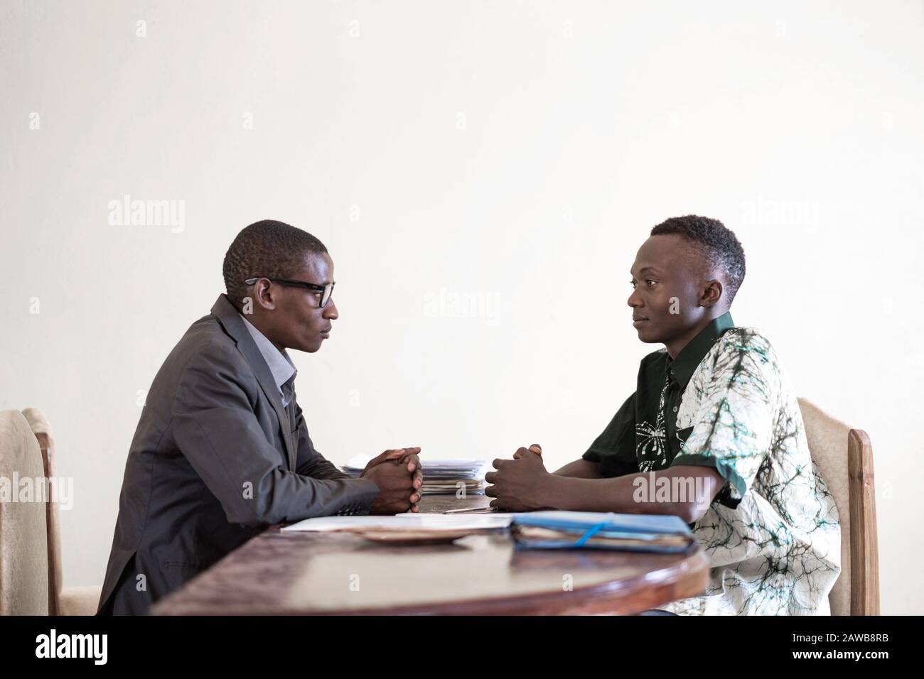 African office scene showing black business person looking at interview ...