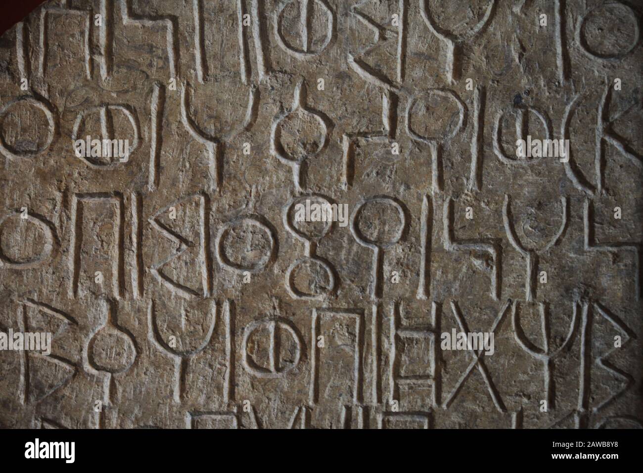 Engraved ancient stonewiht Old Alphabet letters writting from antique ...