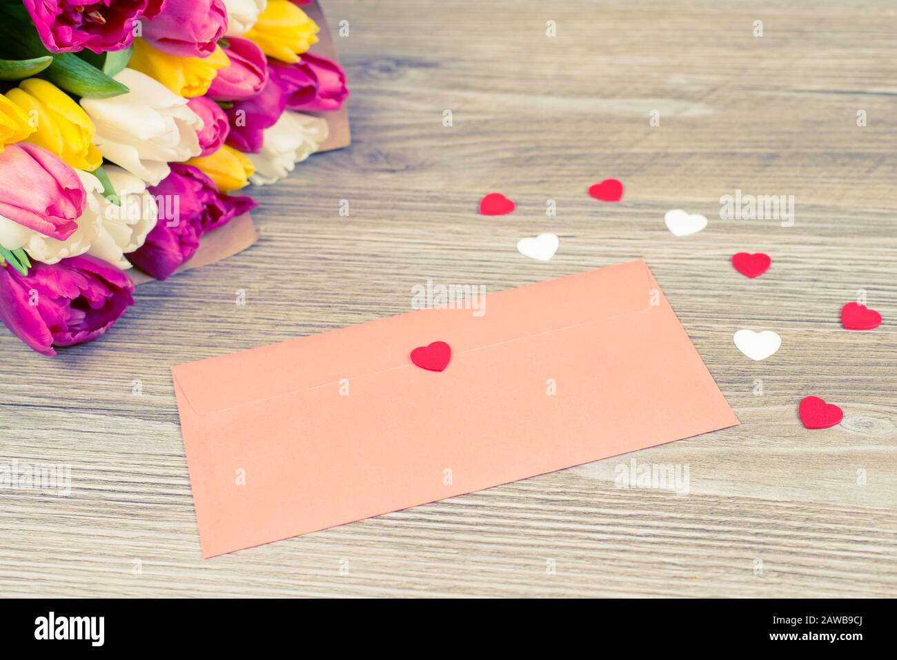 Close-up photo of pastel red envelope with tender poetry inside lying ...