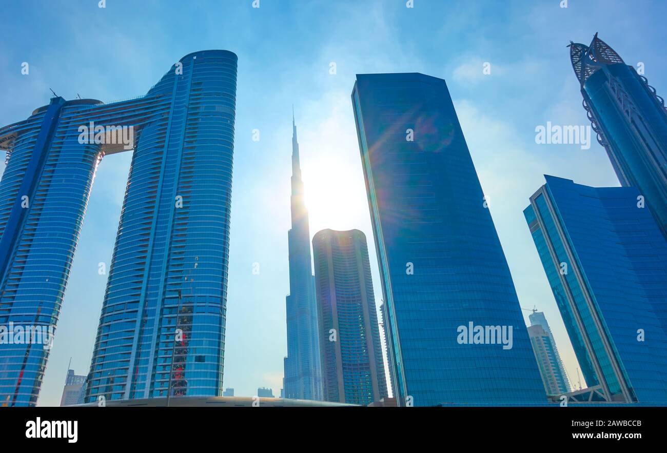 Modern skyscrapers of Downtown Dubai in the sunshine, UAE. Wide angle ...