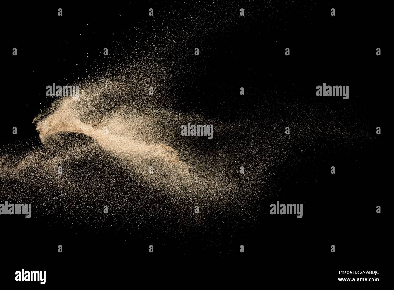 Brown dry river sand explosion isolated on black background. Abstract ...