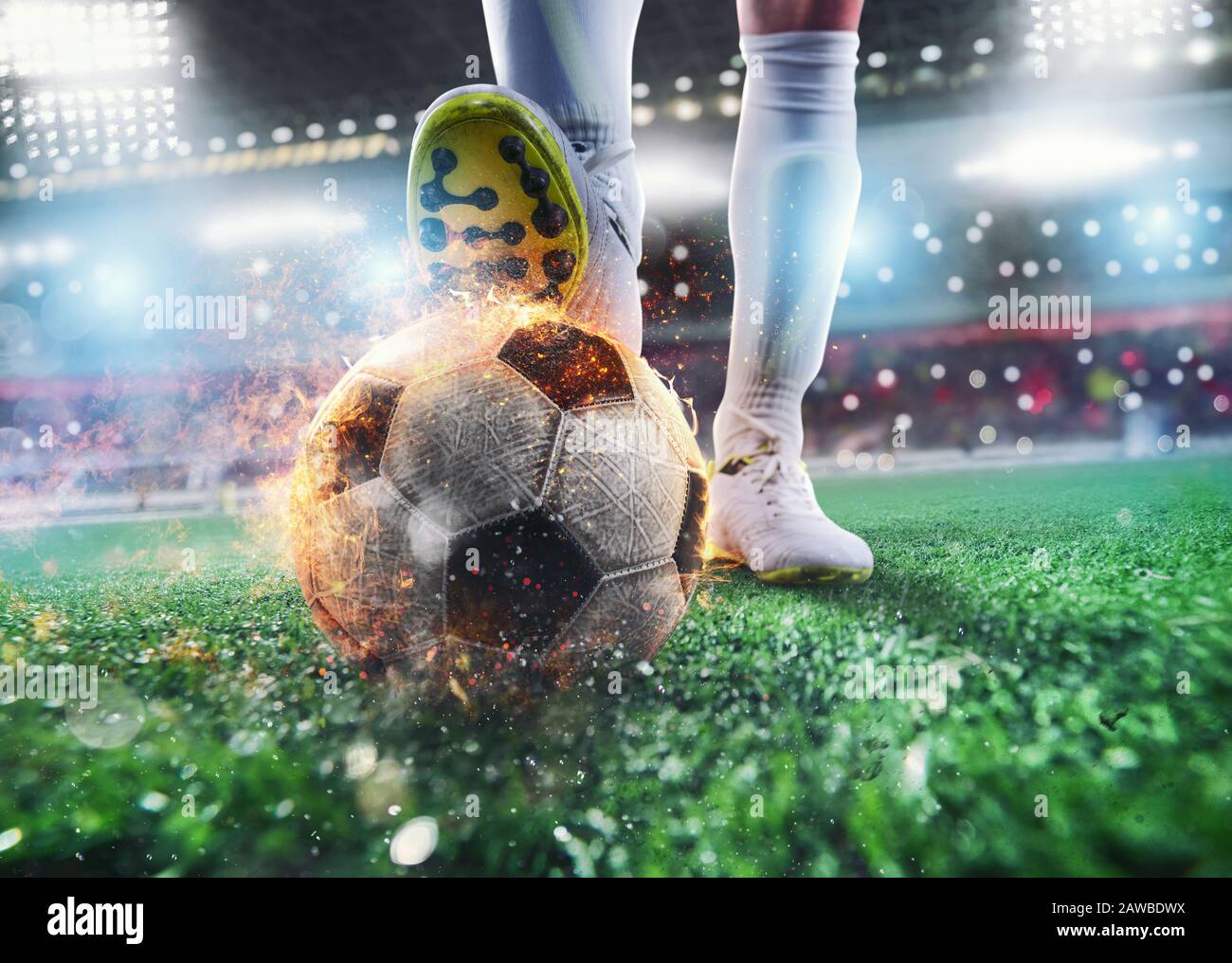 Close up of a soccer striker ready to kicks the fiery ball at the ...